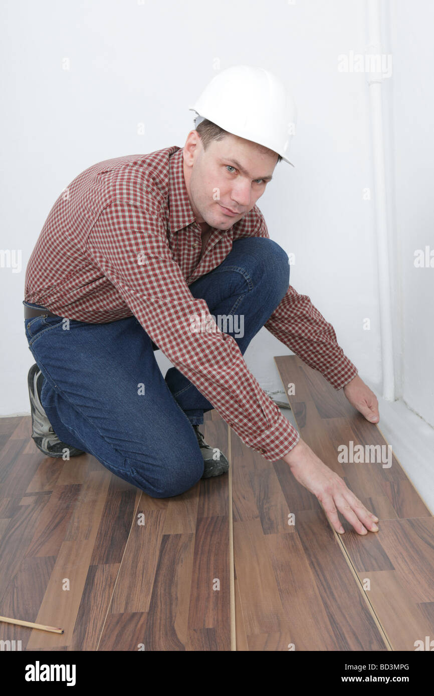 Man making the laminate flooring installation Stock Photo - Alamy