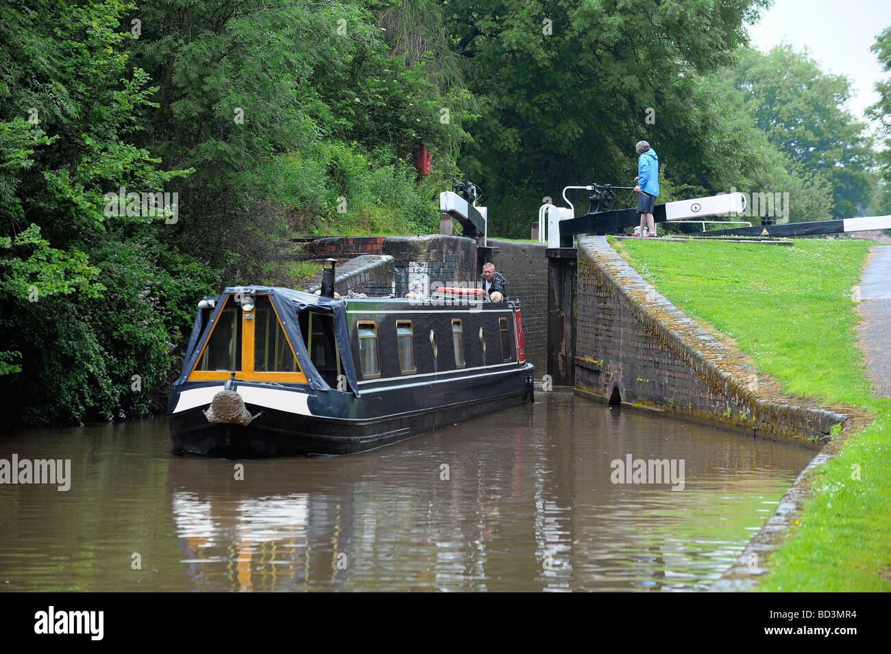 Canal boat leaving a lock on the Worcester Birmingham Canal Stock Photo ...