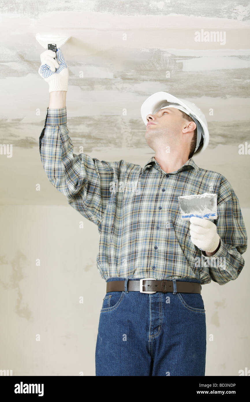 Contractor plastering the ceiling Stock Photo - Alamy