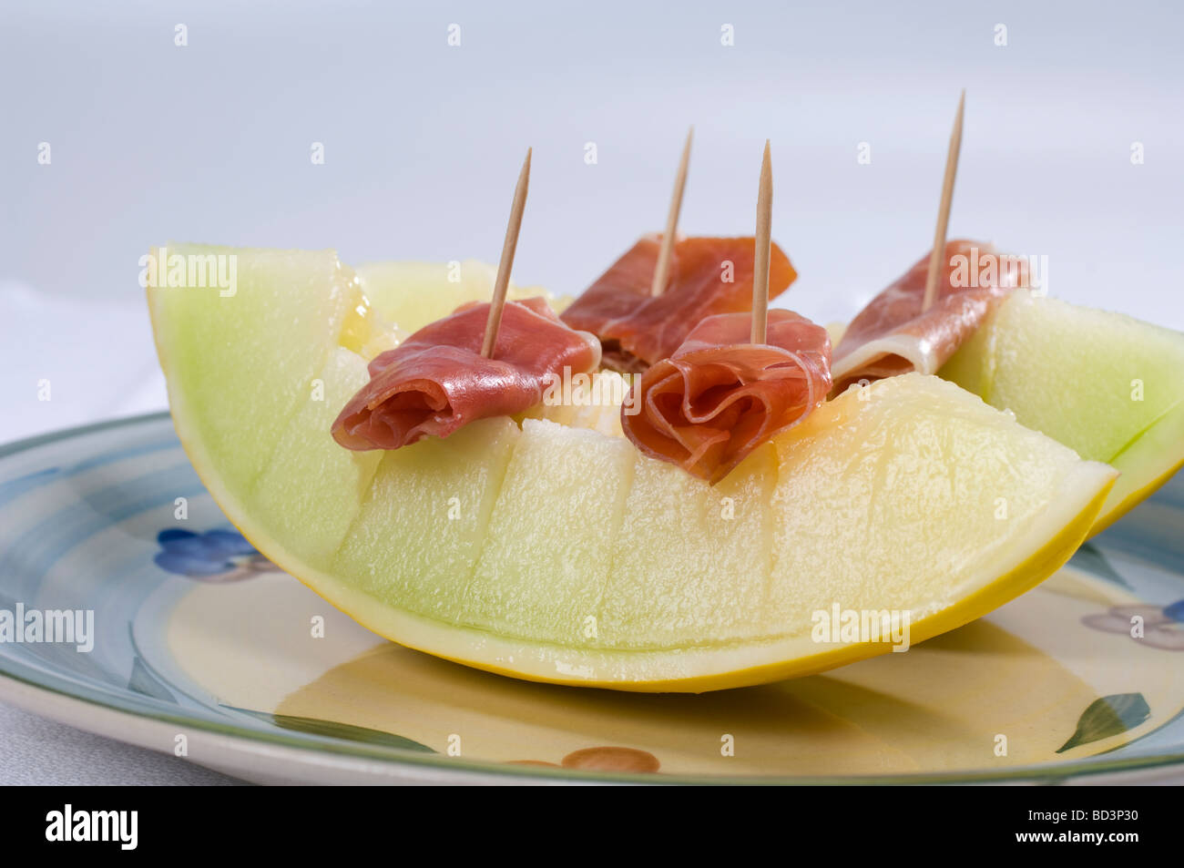 Slices of melon with parma ham Stock Photo - Alamy