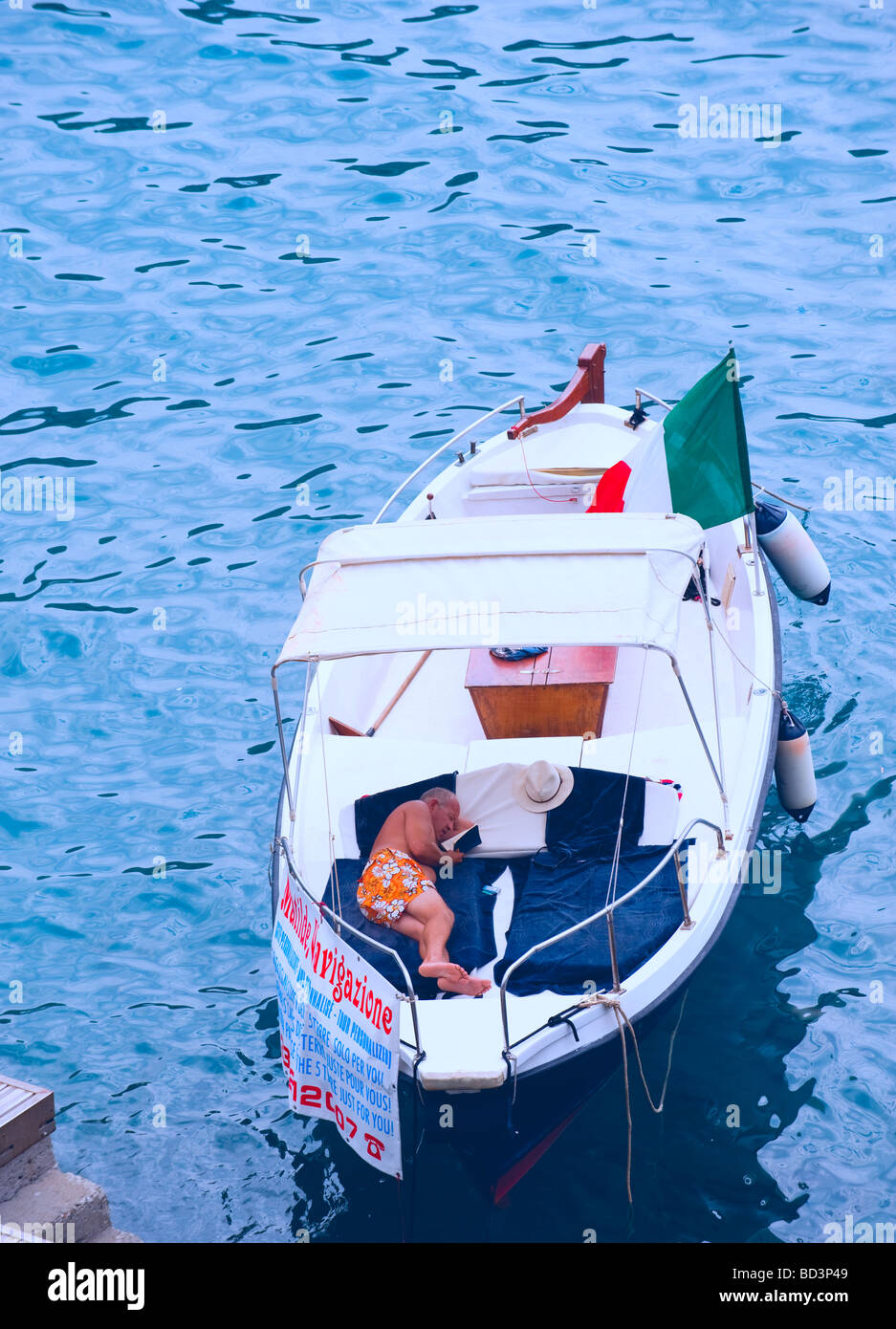 Man resting on his rental boat Stock Photo - Alamy