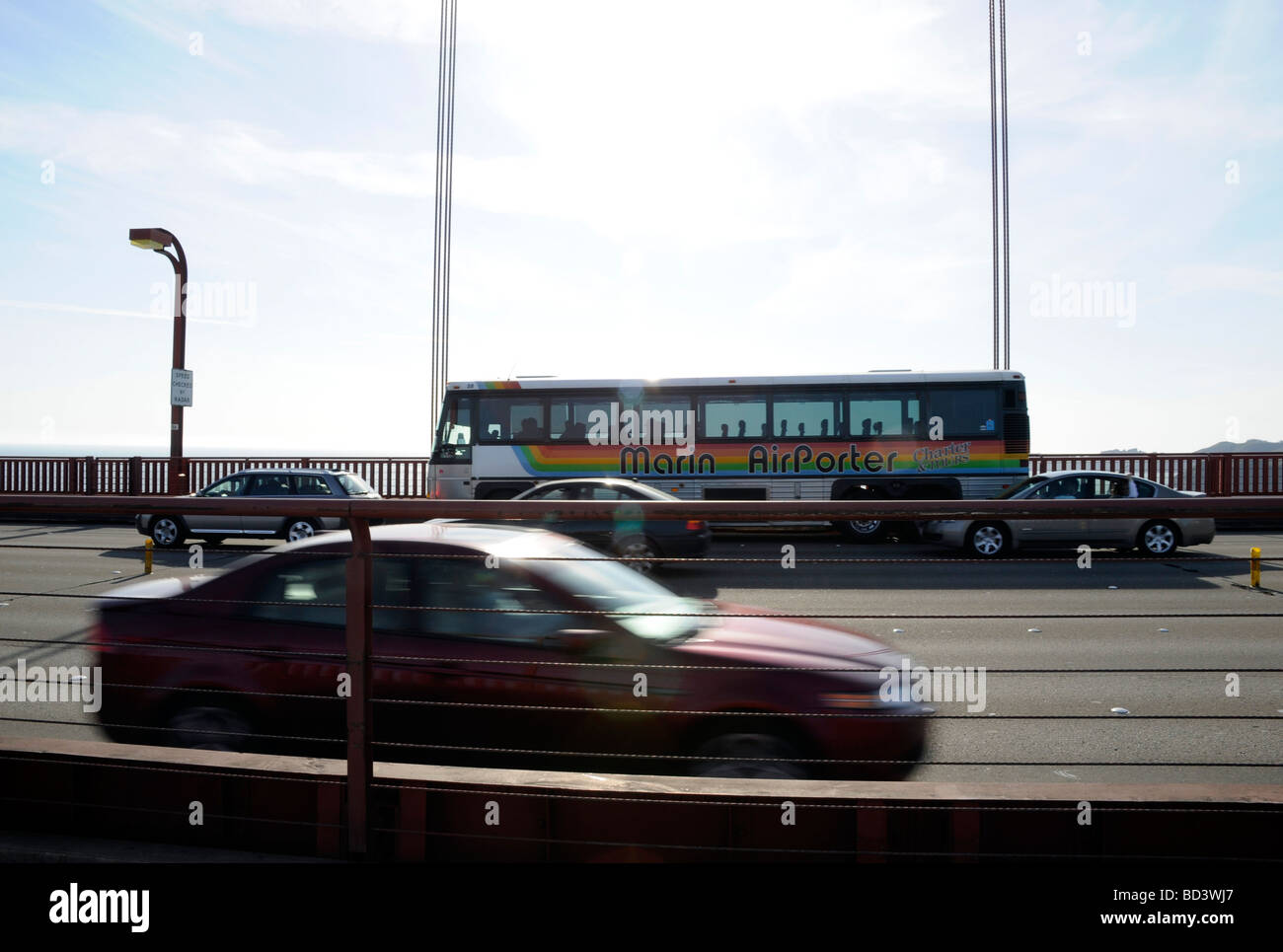 The Marin Airporter "Rainbow Bus" driving across the Golden Gate Bridge ...
