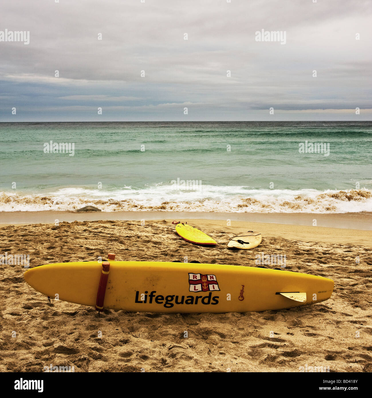 A RNLI lifeguard surf rescue board on the beach at Sennen in Cornwall ...