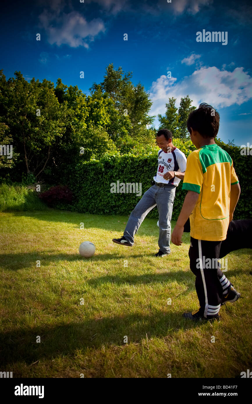 Little Kids Playing Football In Backyard