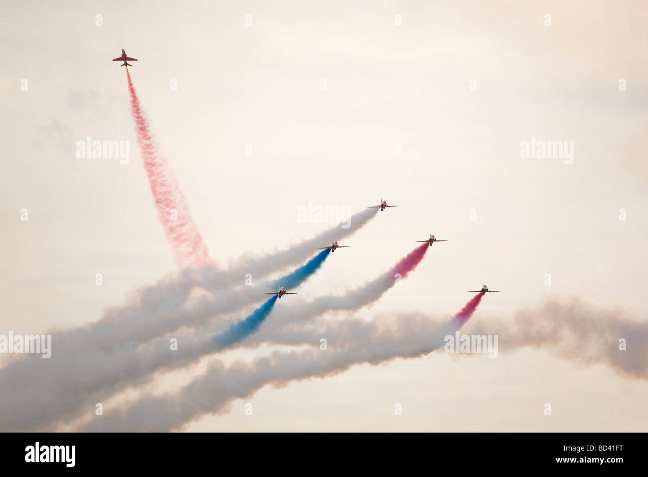 The Red Arrows fly trailing coloured smoke in formation at the ...