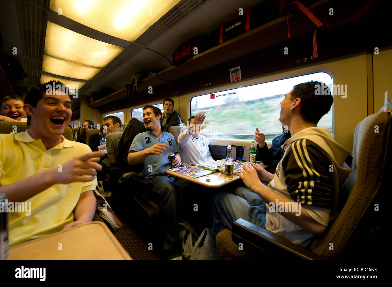 Young white European males celebrating on a train journey Stock Photo ...