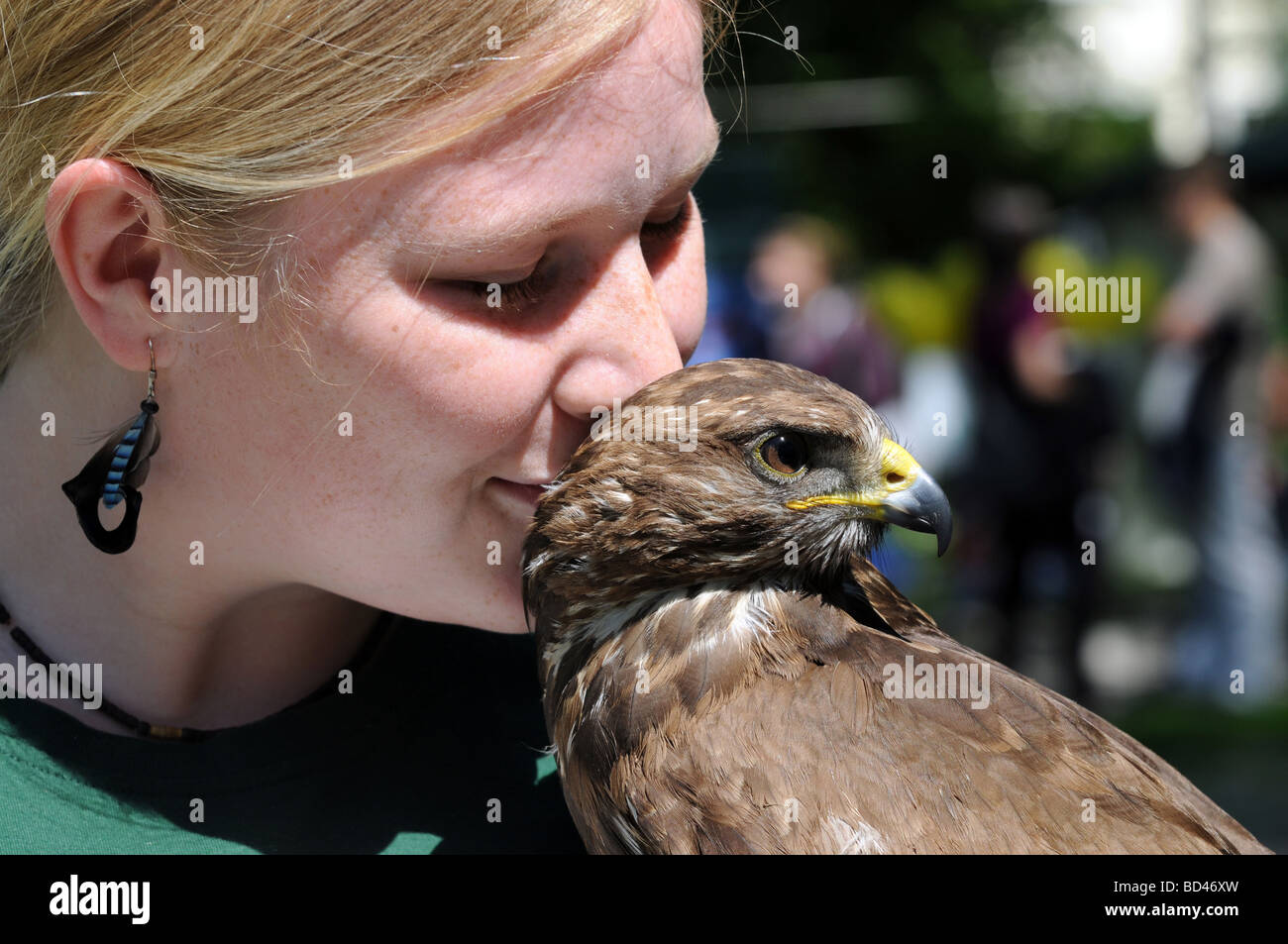 Young woman kissing her Common Buzzard bird (Buteo buteo Stock Photo ...