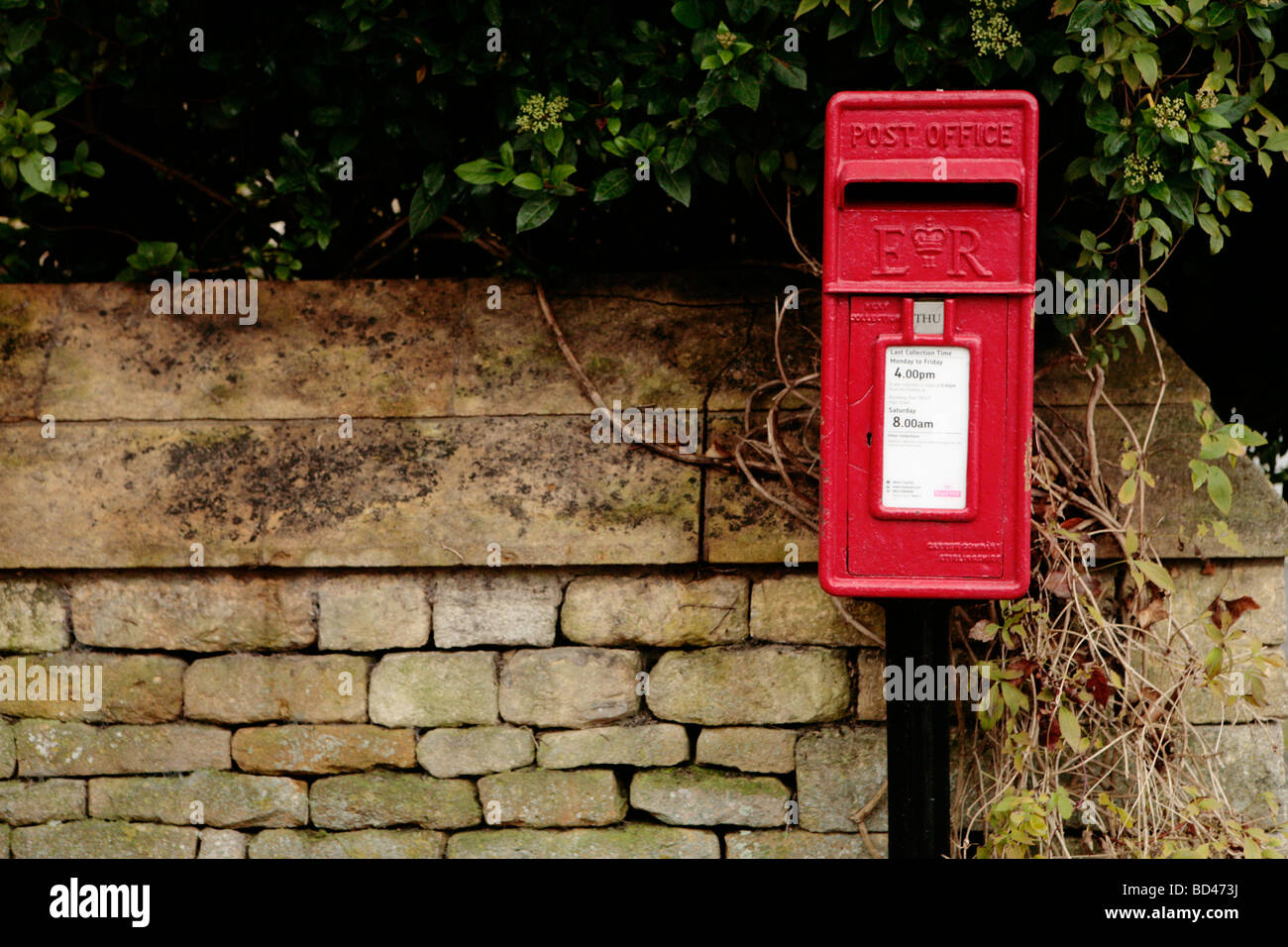 Red letter box against a stone wall in the Cotswolds, UK Stock Photo ...