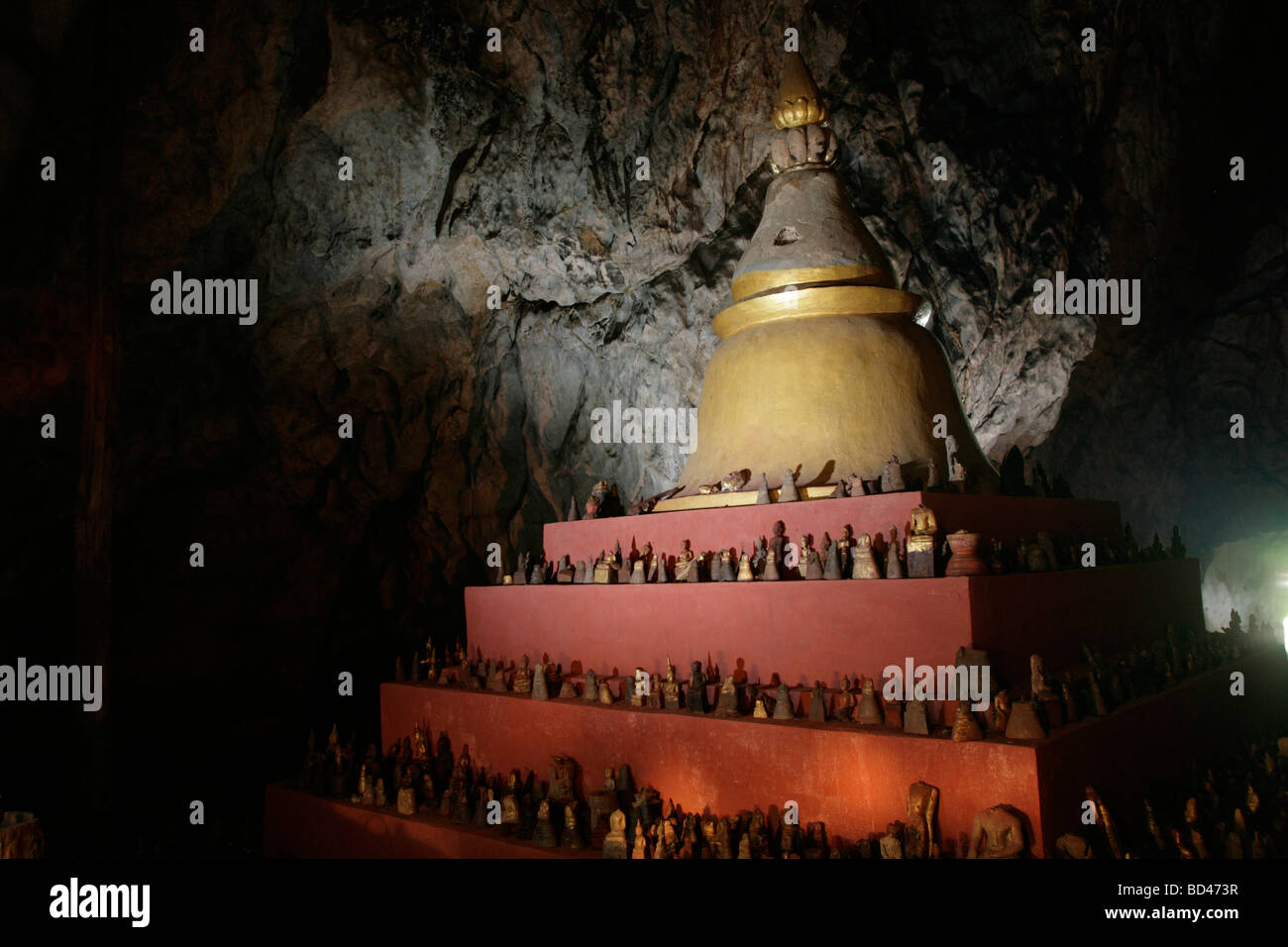 A stoopa within the limestone caverns of the Pak Ou Caves surrounded by ...