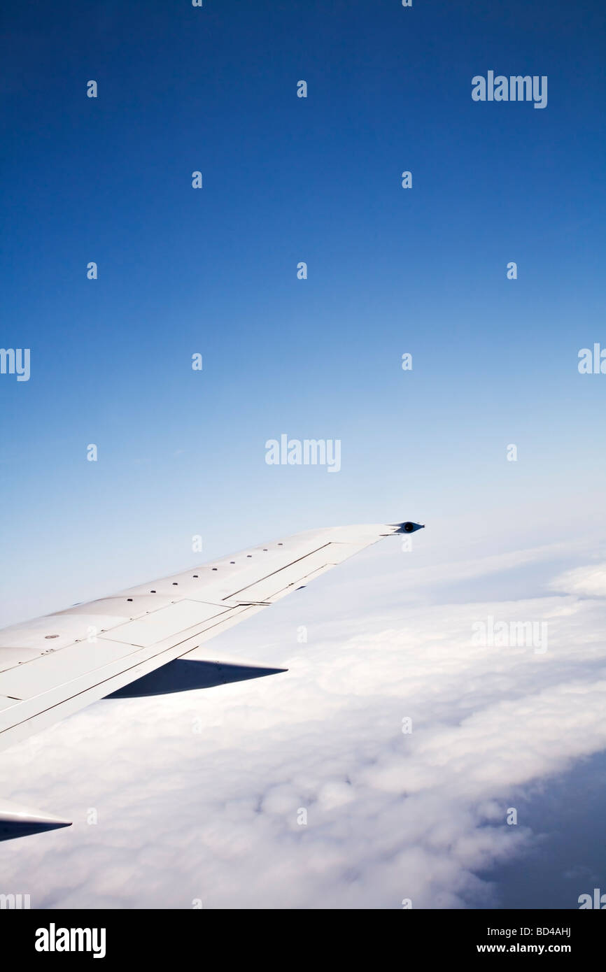 View from an aircraft window of an airplane wing and the Earth below ...