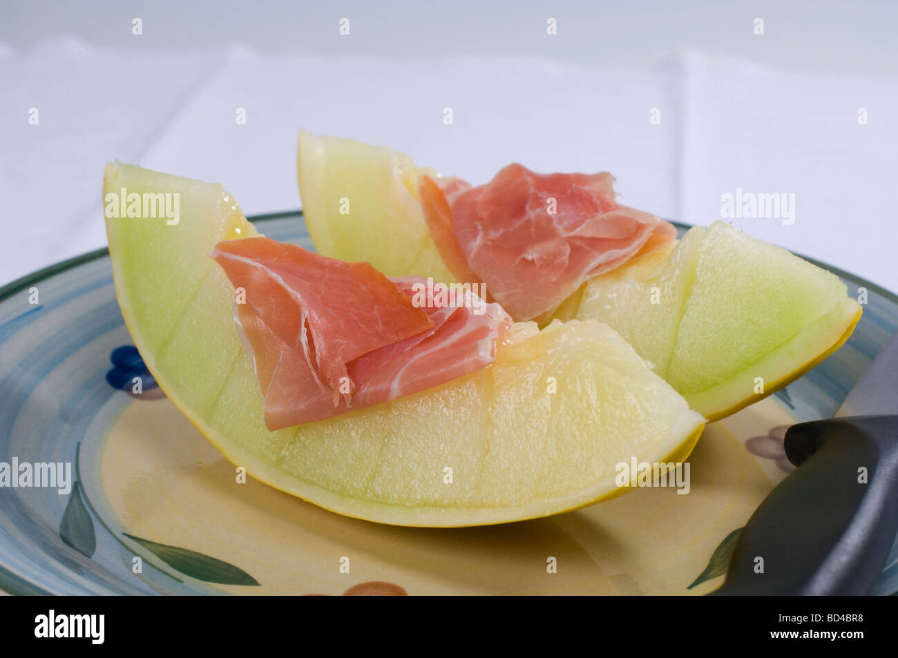 Slices of melon with parma ham Stock Photo - Alamy