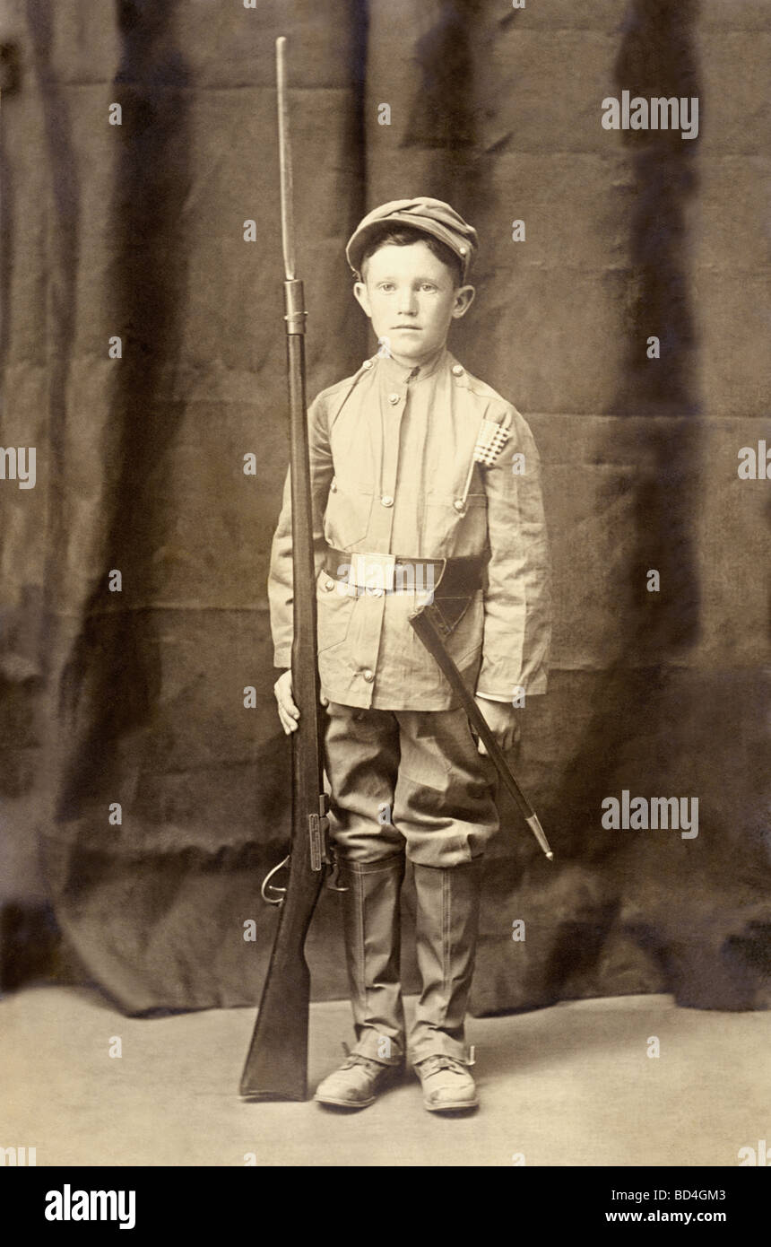 Little Boy in Army Uniform & Long Rifle Stock Photo - Alamy
