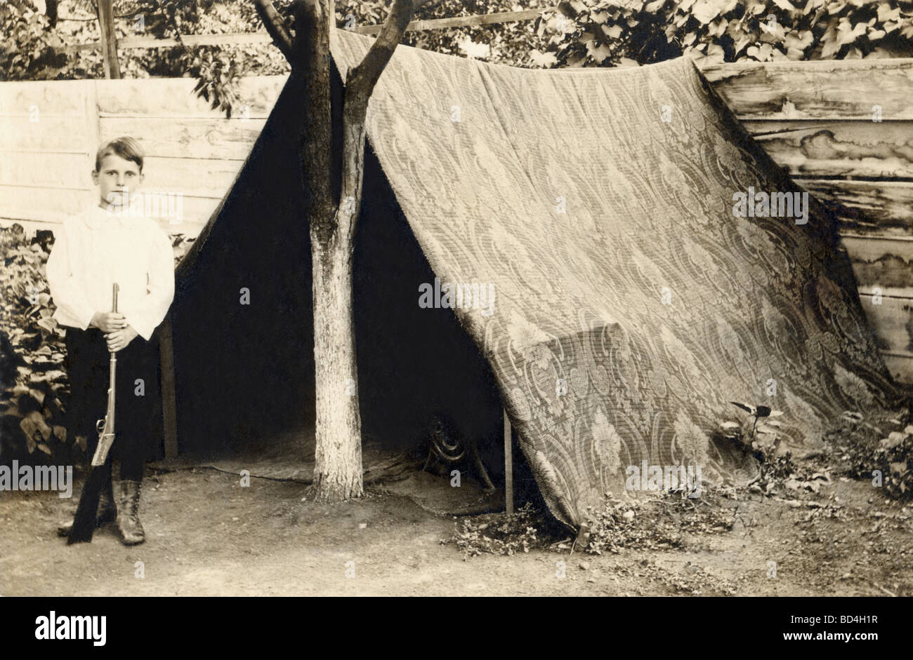 Boy Doing Guard Duty at Backyard Tent Stock Photo - Alamy