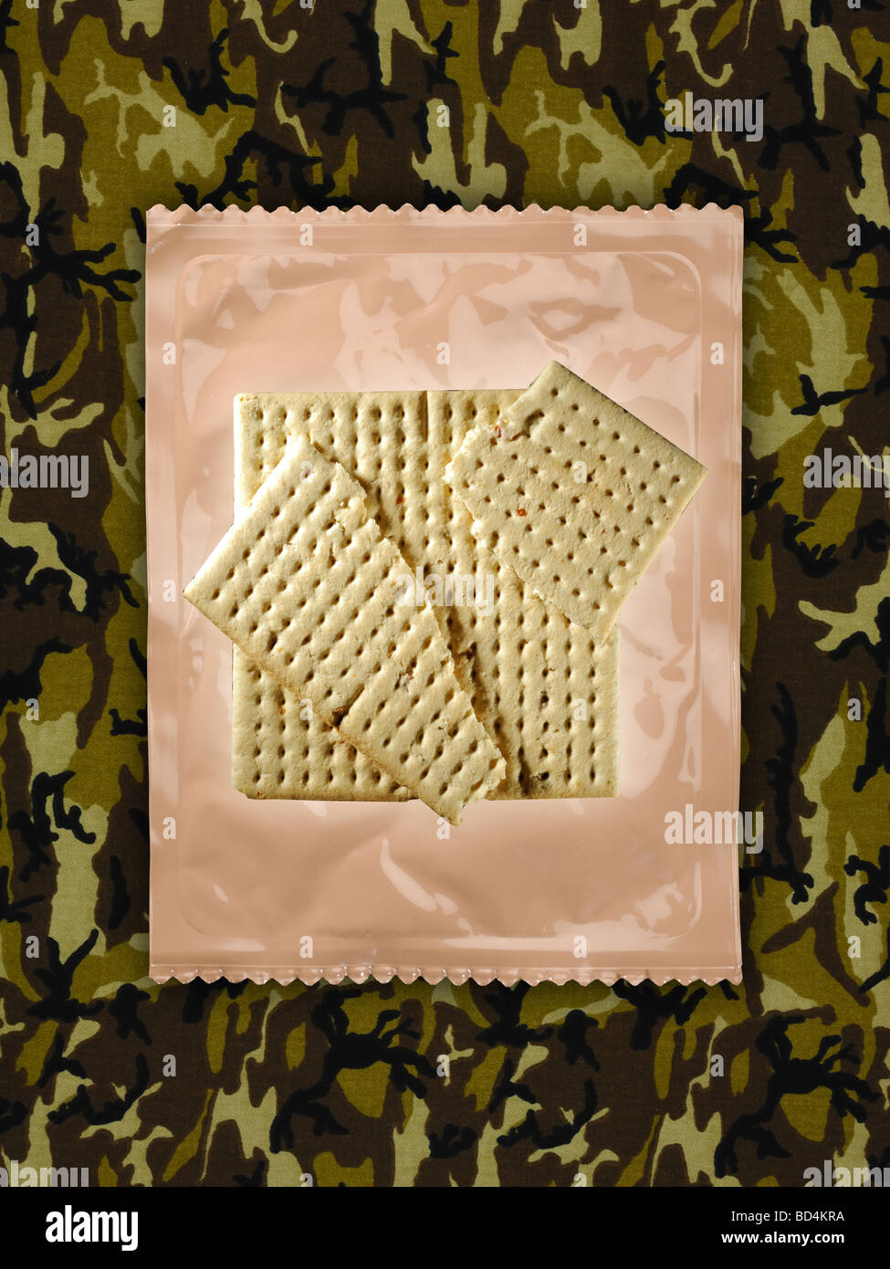 A military food ration package with crackers on a background of green ...