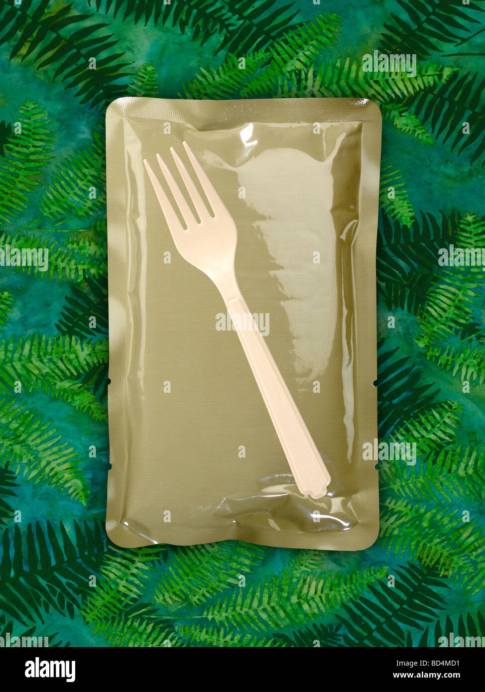 One plastic military food ration package with a plastic fork on a ...