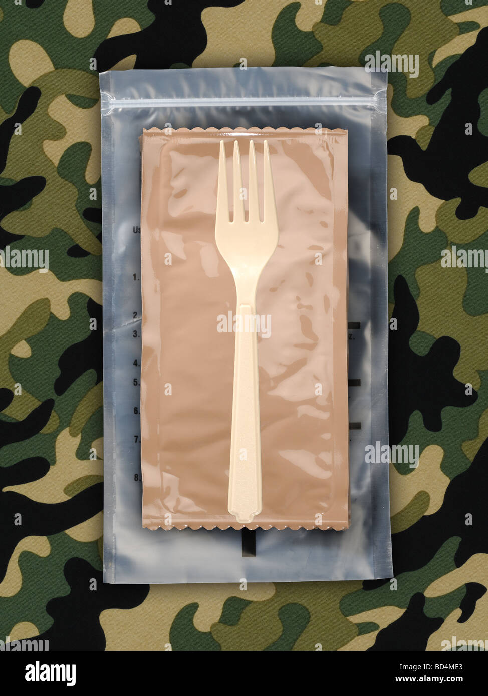 One plastic military food ration package with a plastic fork on a ...