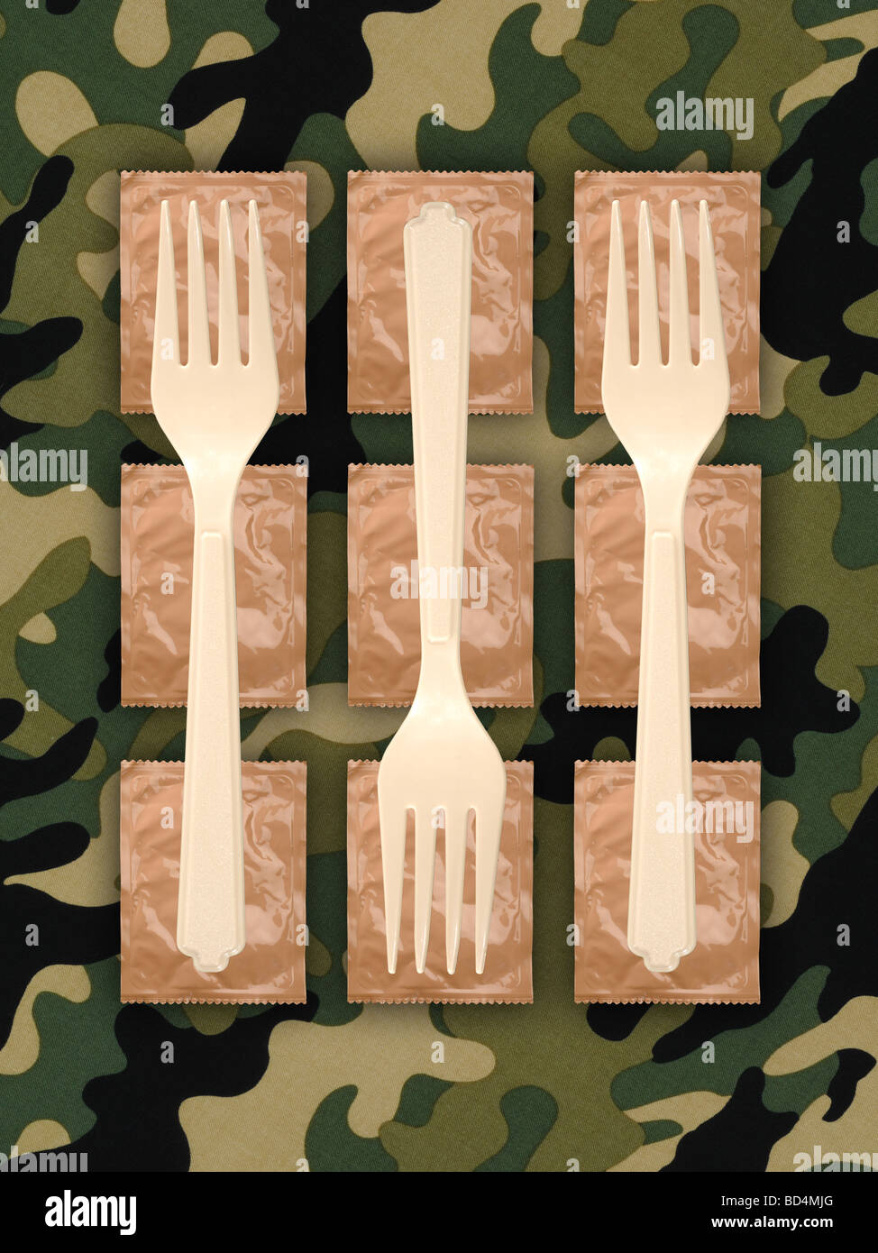 Nine military food ration packages with large plastic forks on a ...