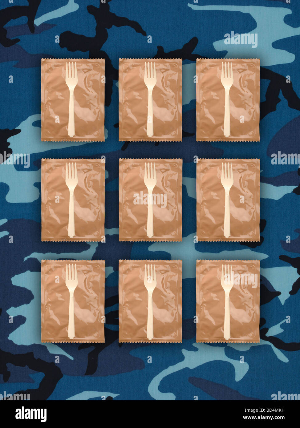 Nine military food ration packages with utensils on a background of ...