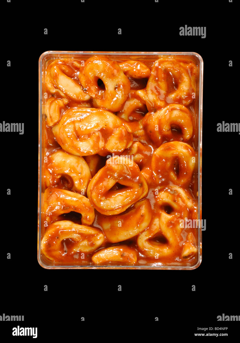 A plastic container with military food rations, cheese tortellini pasta ...