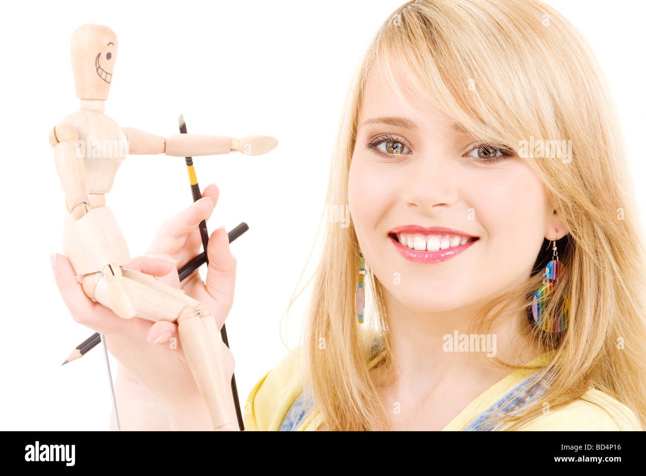 happy teenage girl with wooden model dummy over white Stock Photo - Alamy