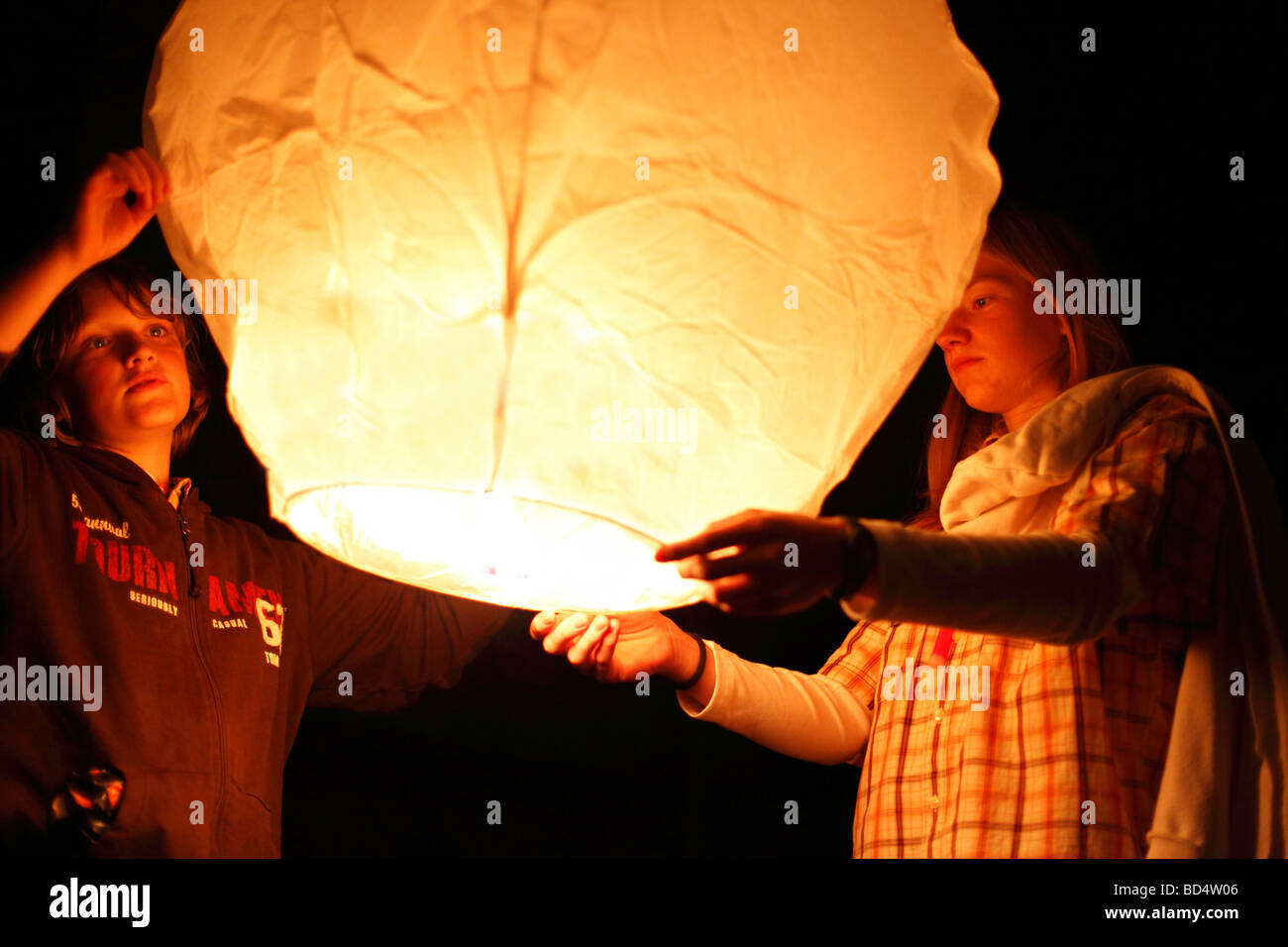 teenager launch sky lantern; hot air balloon; floating lantern Stock ...