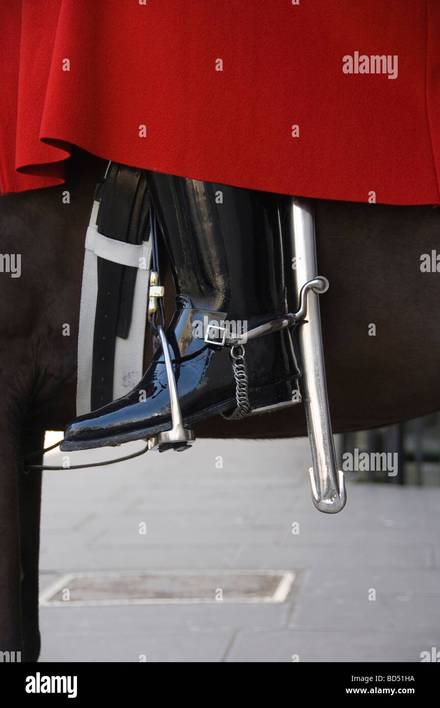 Close up of a shiny Cavalry Boot and red tunic of solider on guard in ...