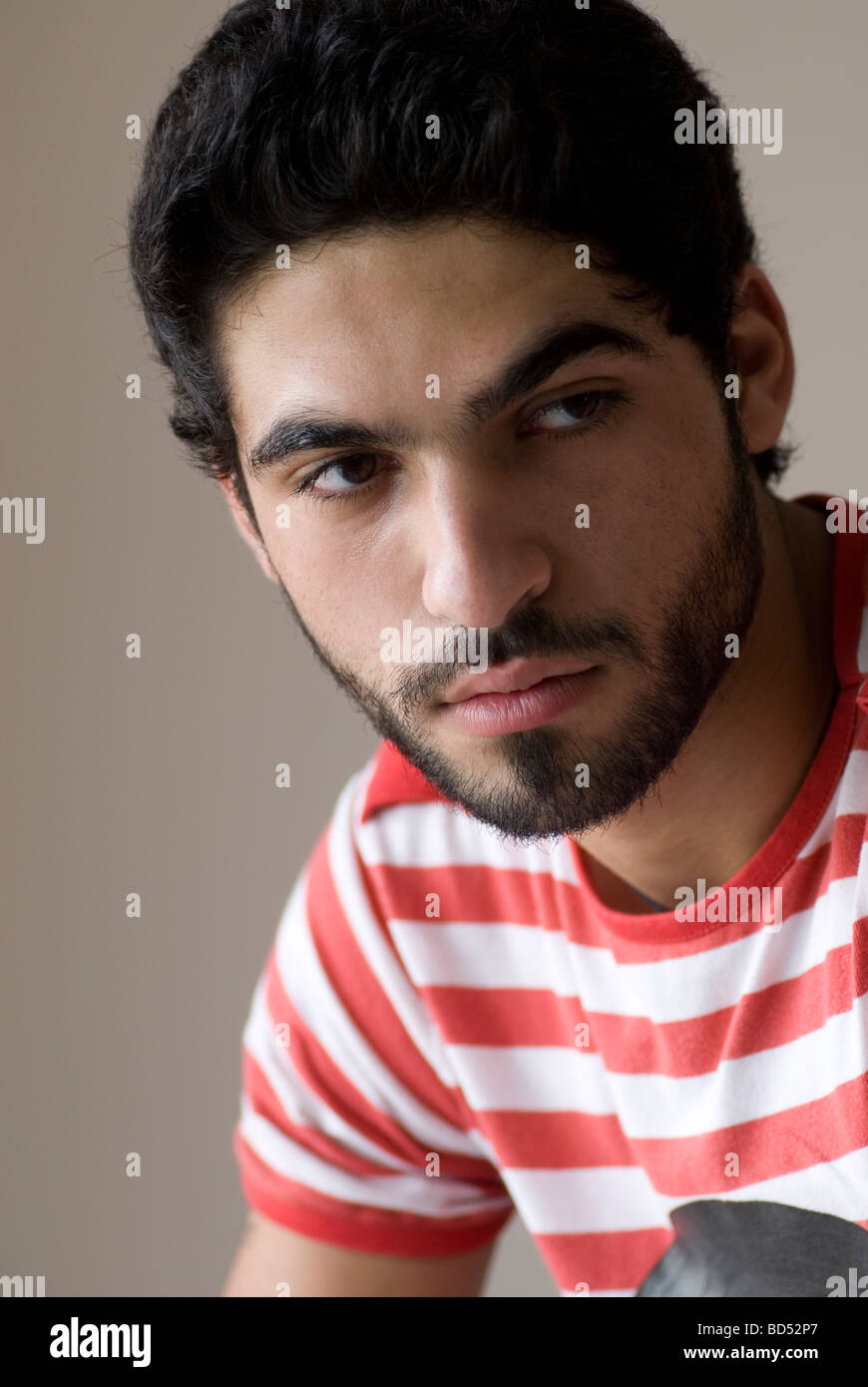 Young Arabic man looking away Stock Photo - Alamy