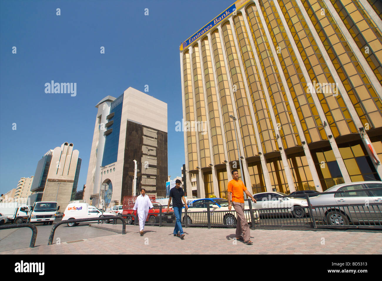 People and cars in front of office and bank buldings at the Dubai Creek ...