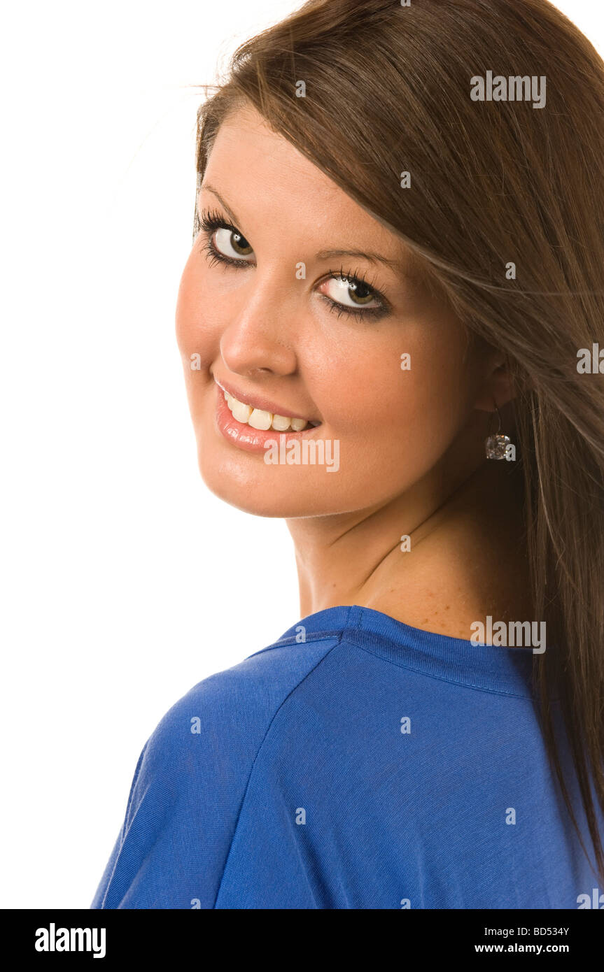 Young woman looking back in blue top Stock Photo - Alamy