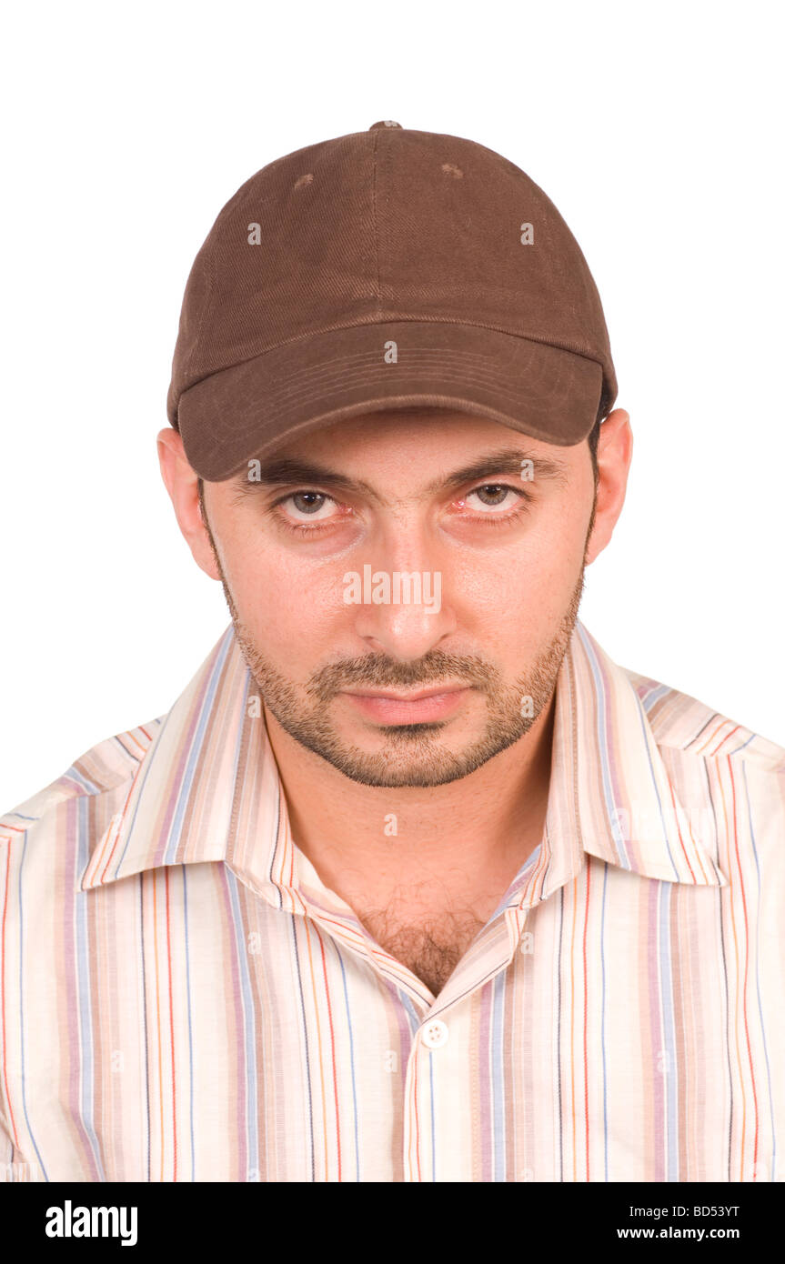 Man wearing a baseball cap staring at camera against a white background ...