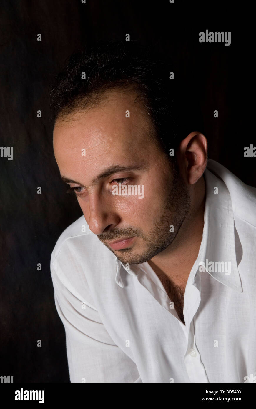 Sad man looking down Stock Photo - Alamy