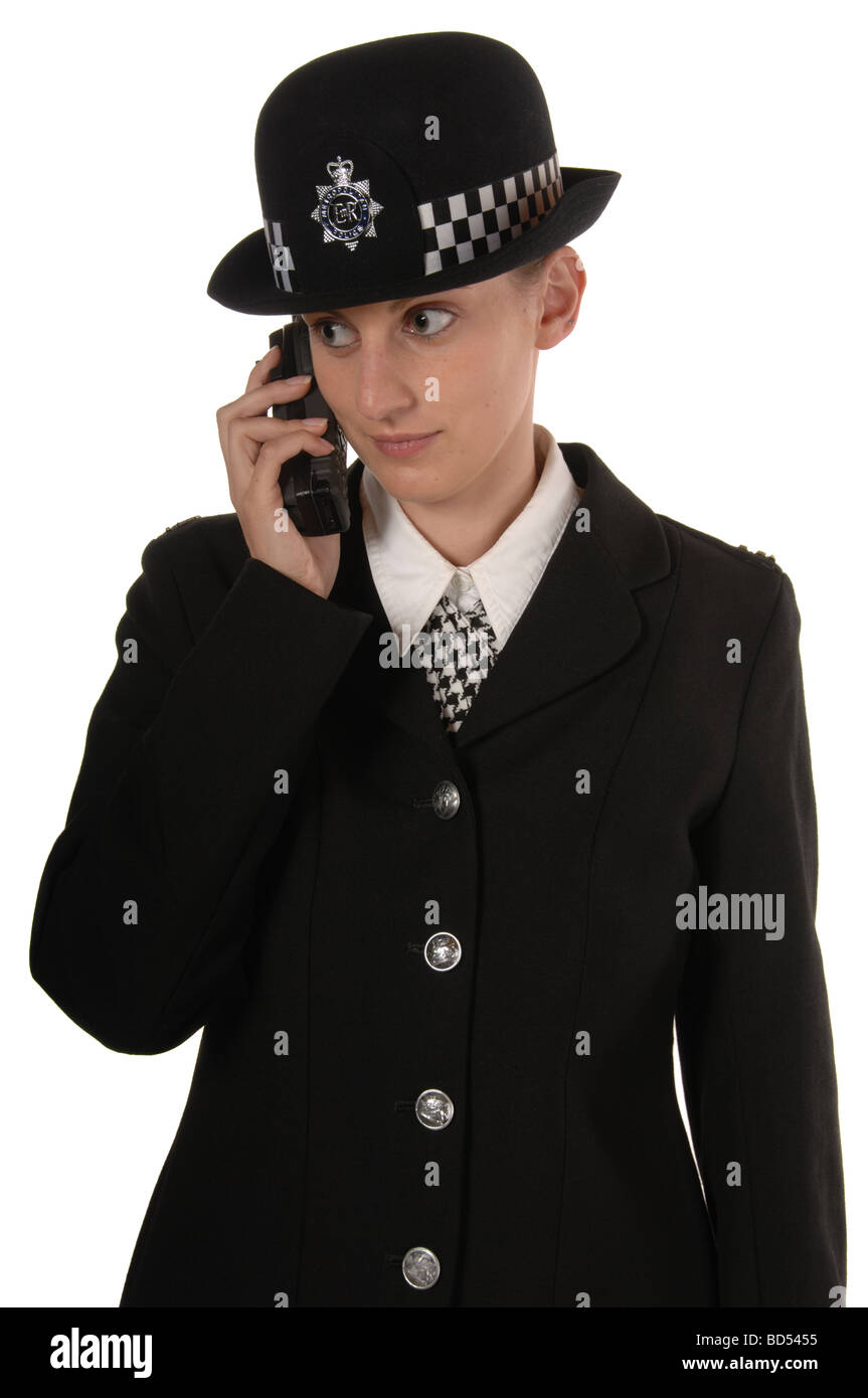 Uniformed UK female police officer using her radio isolated on white ...