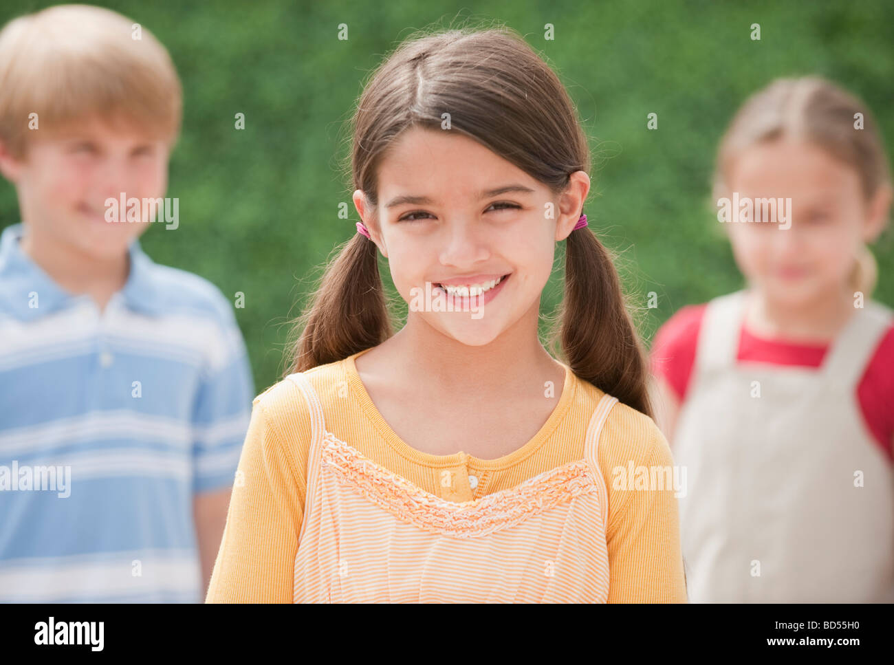 Three children outdoors Stock Photo - Alamy