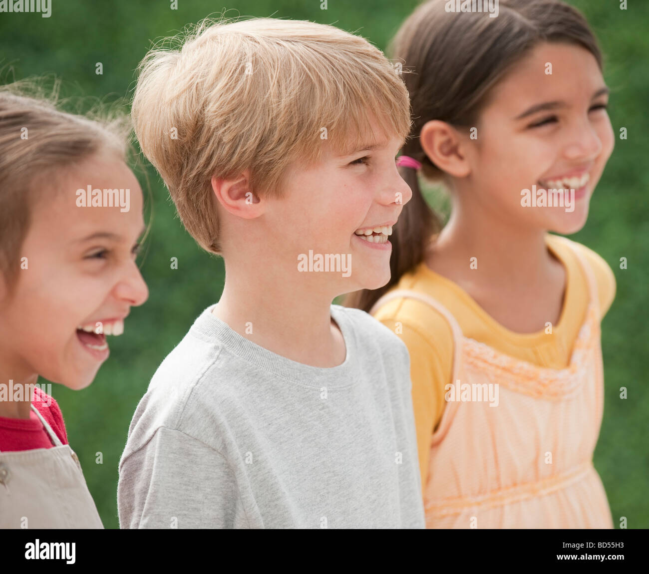 Three children outdoors Stock Photo - Alamy