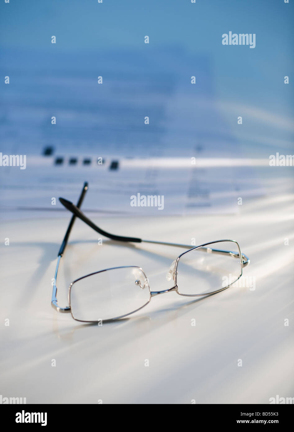 Eyeglasses near some paperwork Stock Photo - Alamy