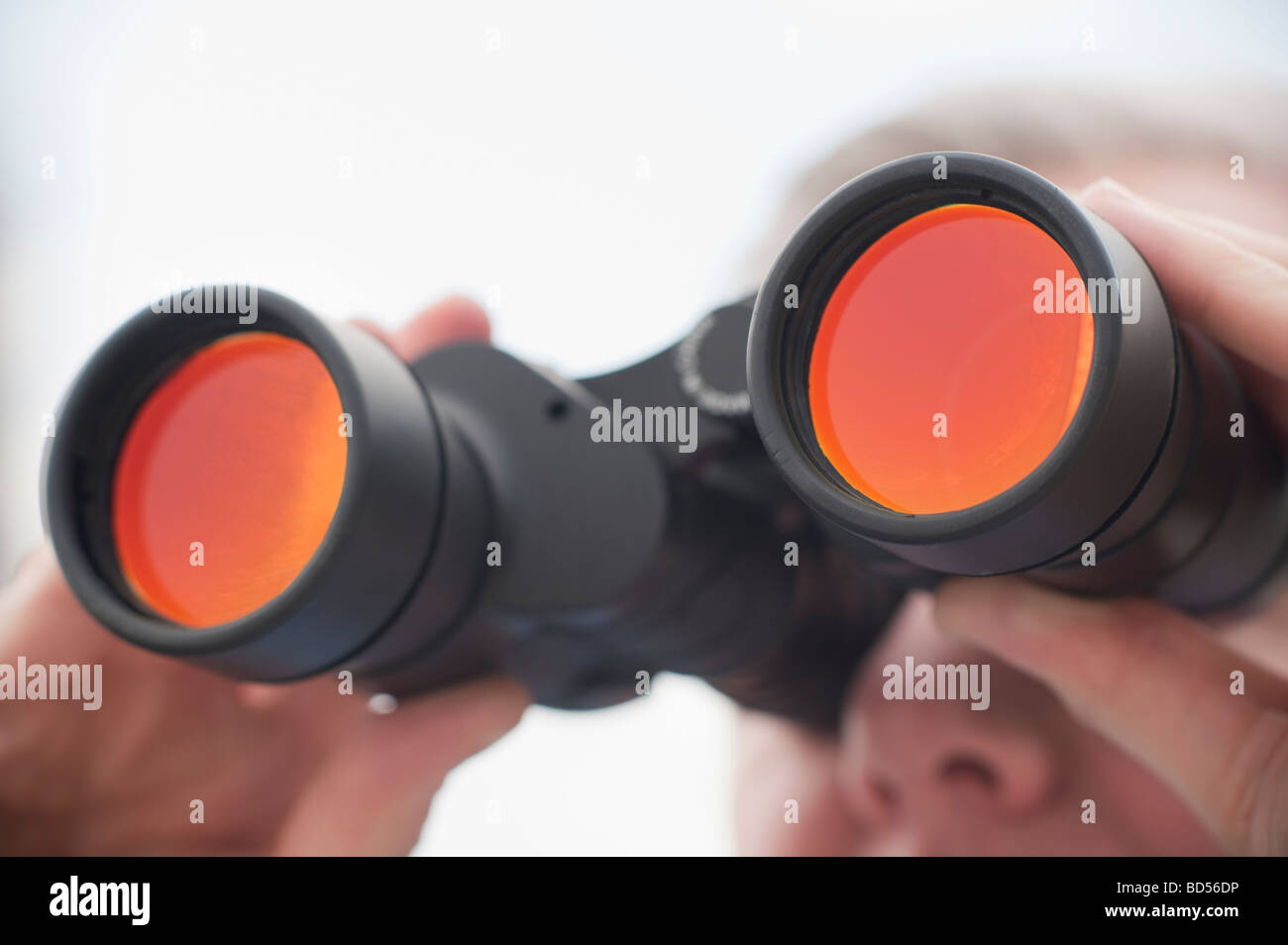 Man using binoculars Stock Photo - Alamy