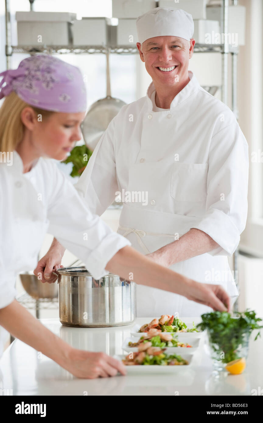 Chefs making salad in a kitchen Stock Photo - Alamy