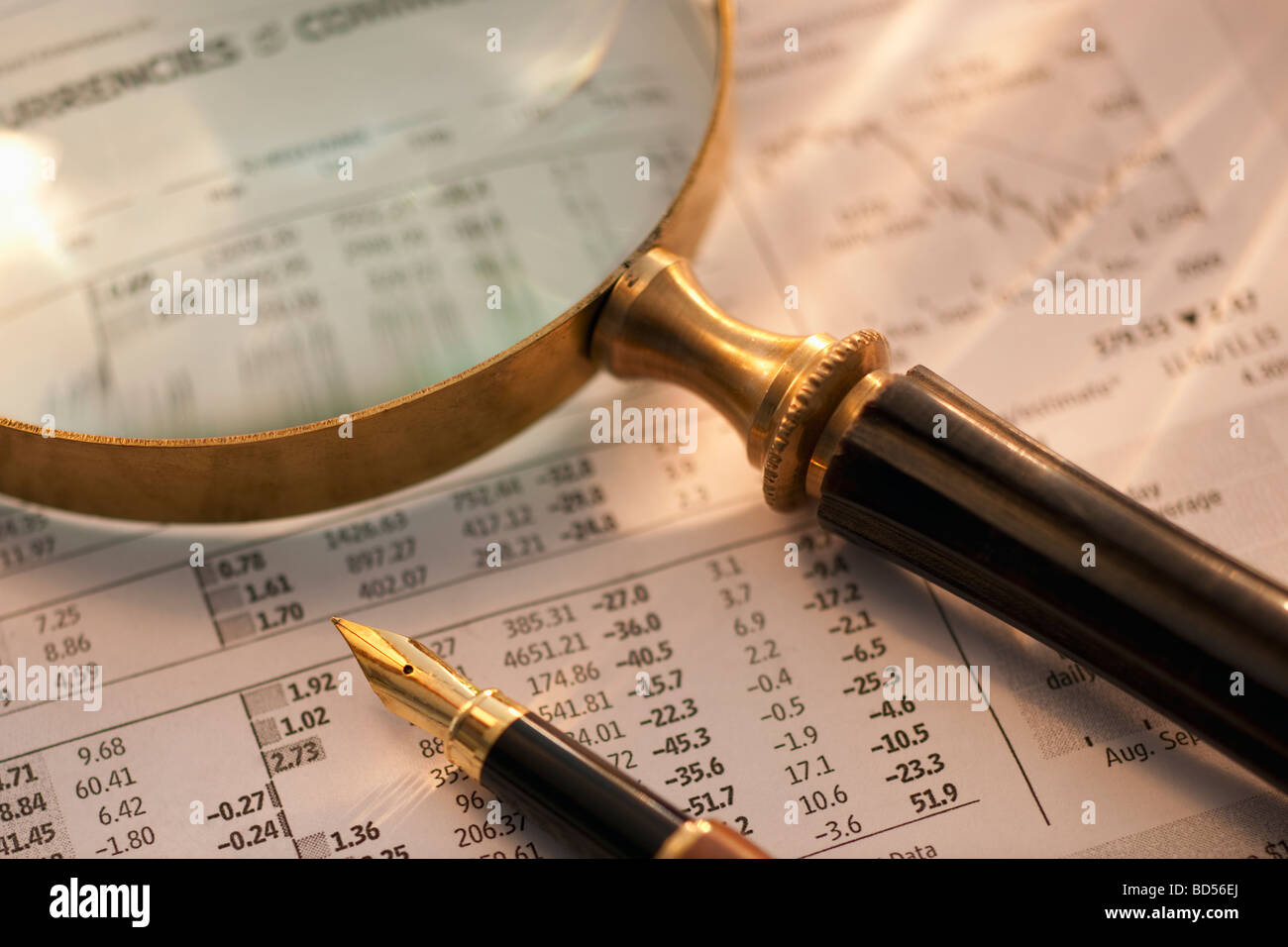 A magnifying glass and pen on paperwork Stock Photo - Alamy