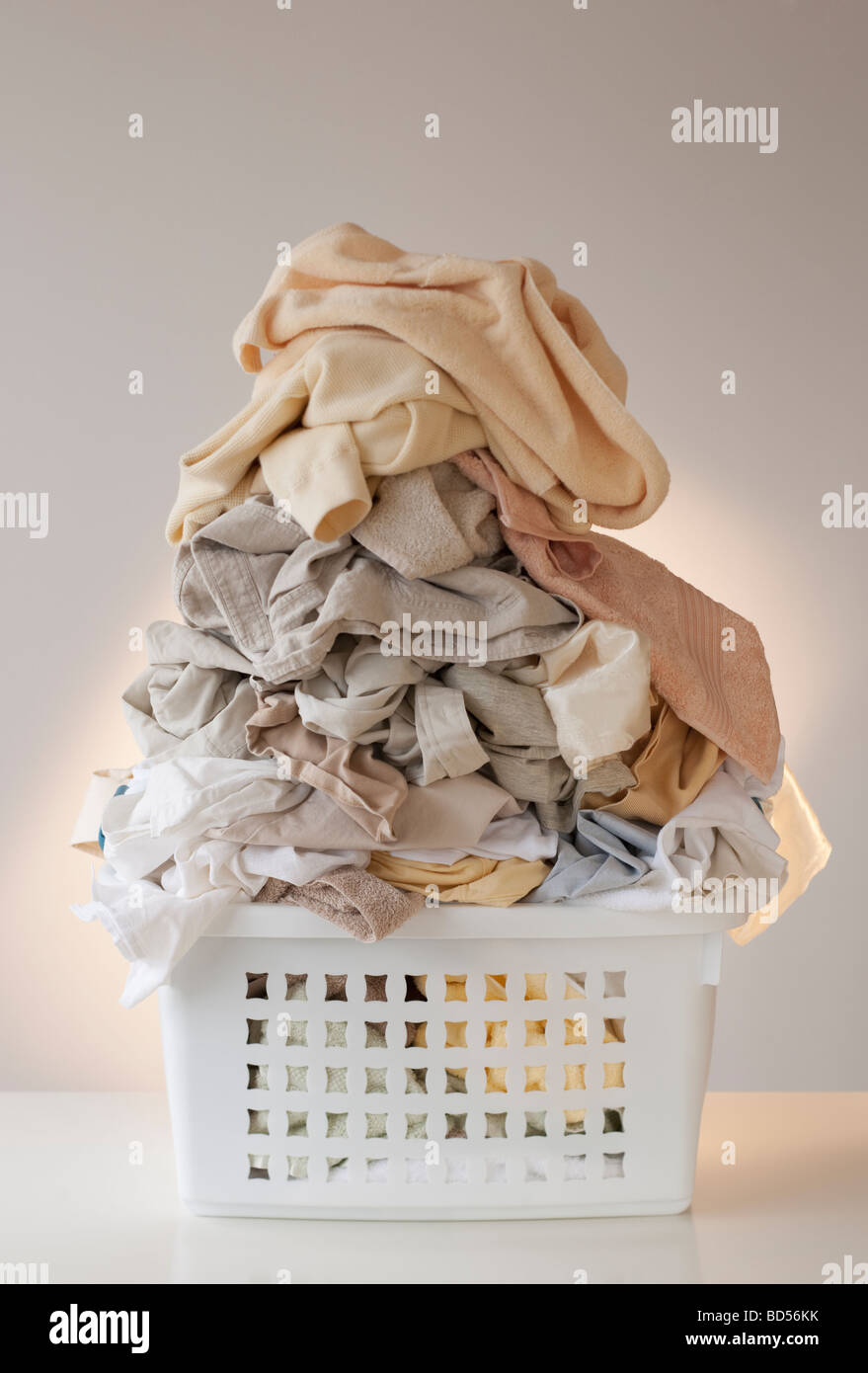 A laundry basket full of clothes Stock Photo - Alamy