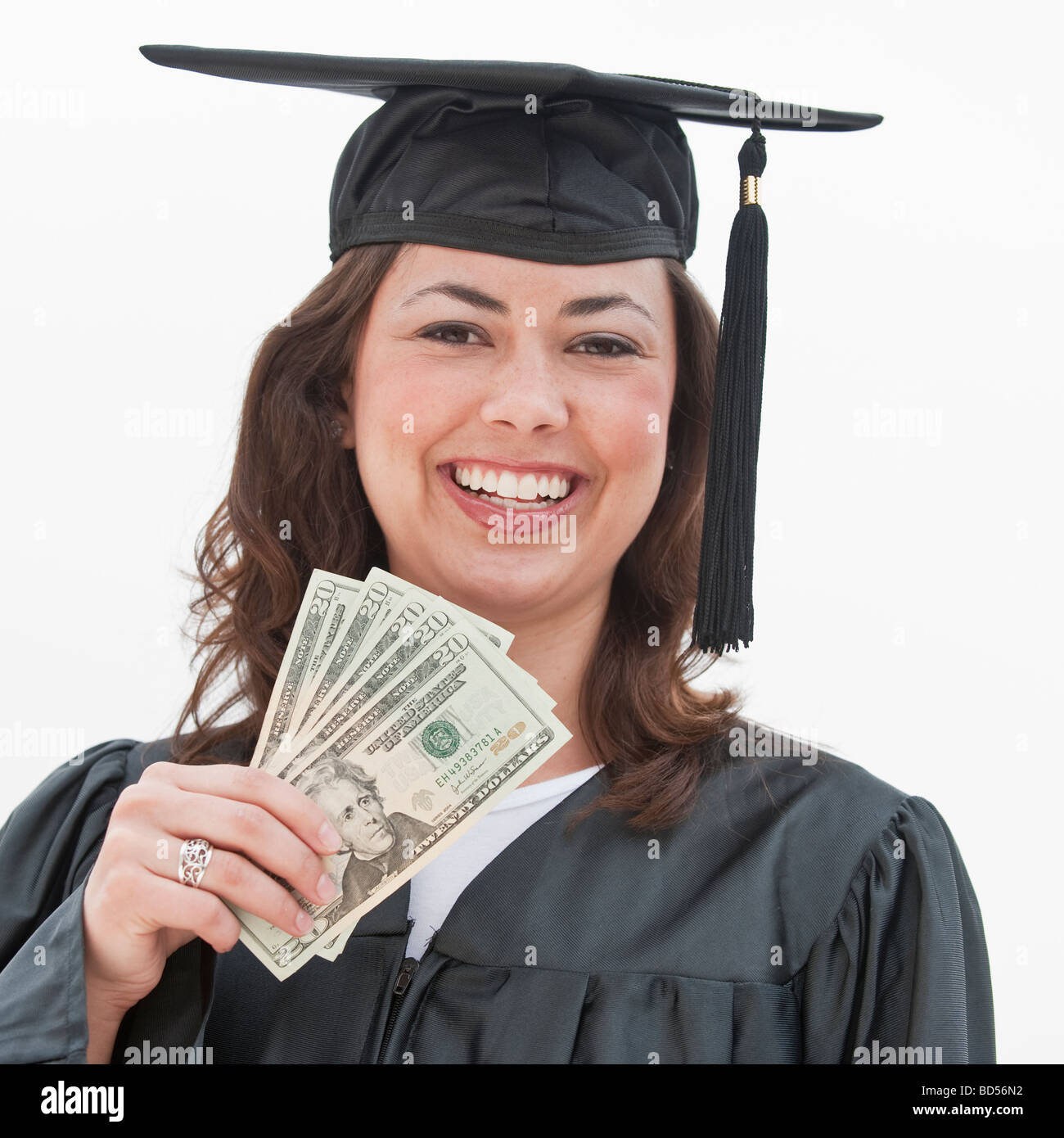 A graduate holding money Stock Photo - Alamy