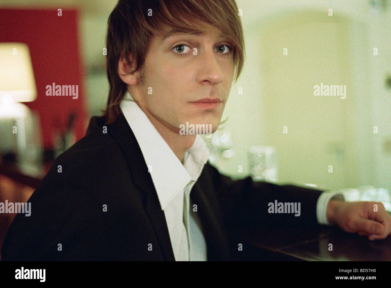 Well dressed young man at bar, looking at camera Stock Photo - Alamy
