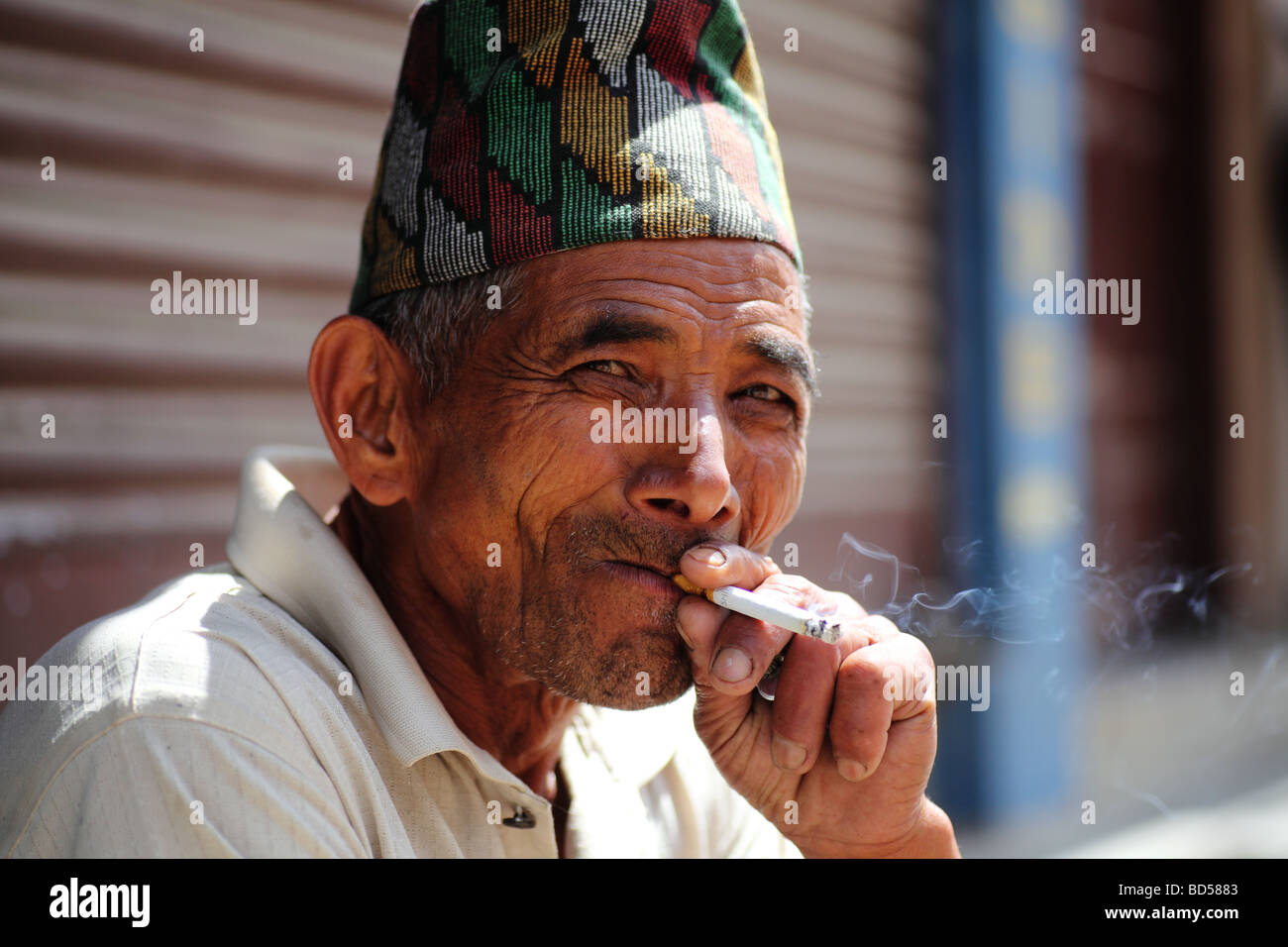 Nepalese man smoking a cigarette Stock Photo - Alamy