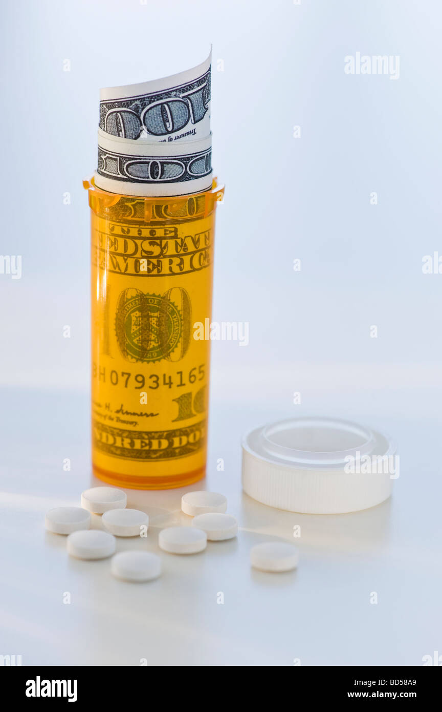 Pill bottle with bank notes Stock Photo - Alamy