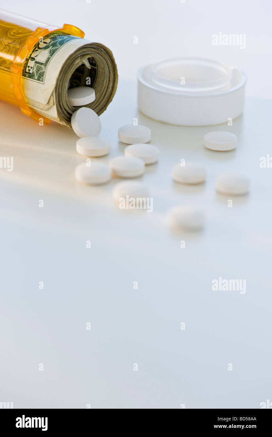 Pill bottle with bank notes Stock Photo - Alamy