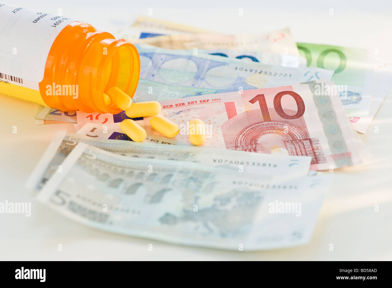 Pill bottle with bank notes Stock Photo - Alamy