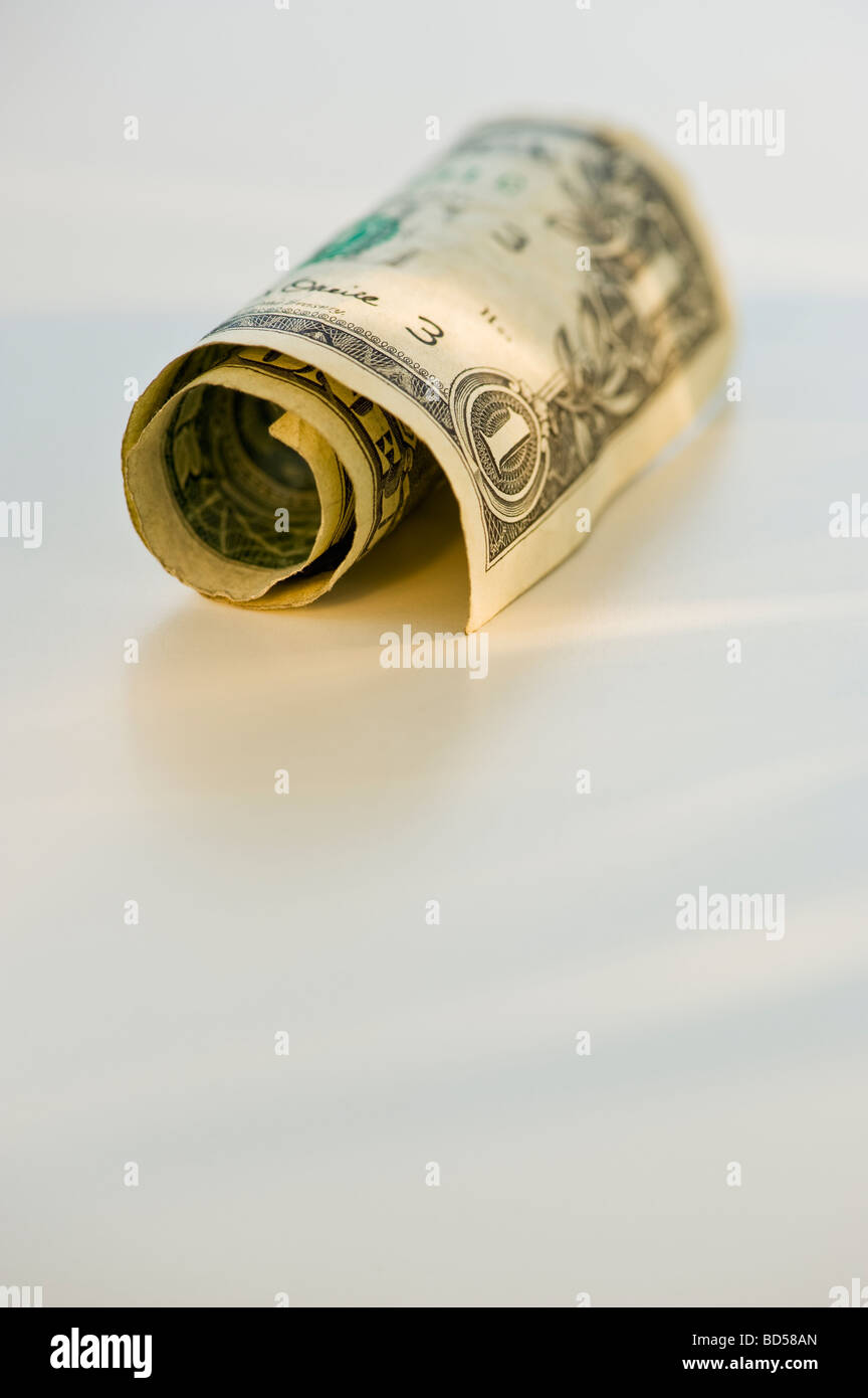 Rolled up dollar bill Stock Photo - Alamy
