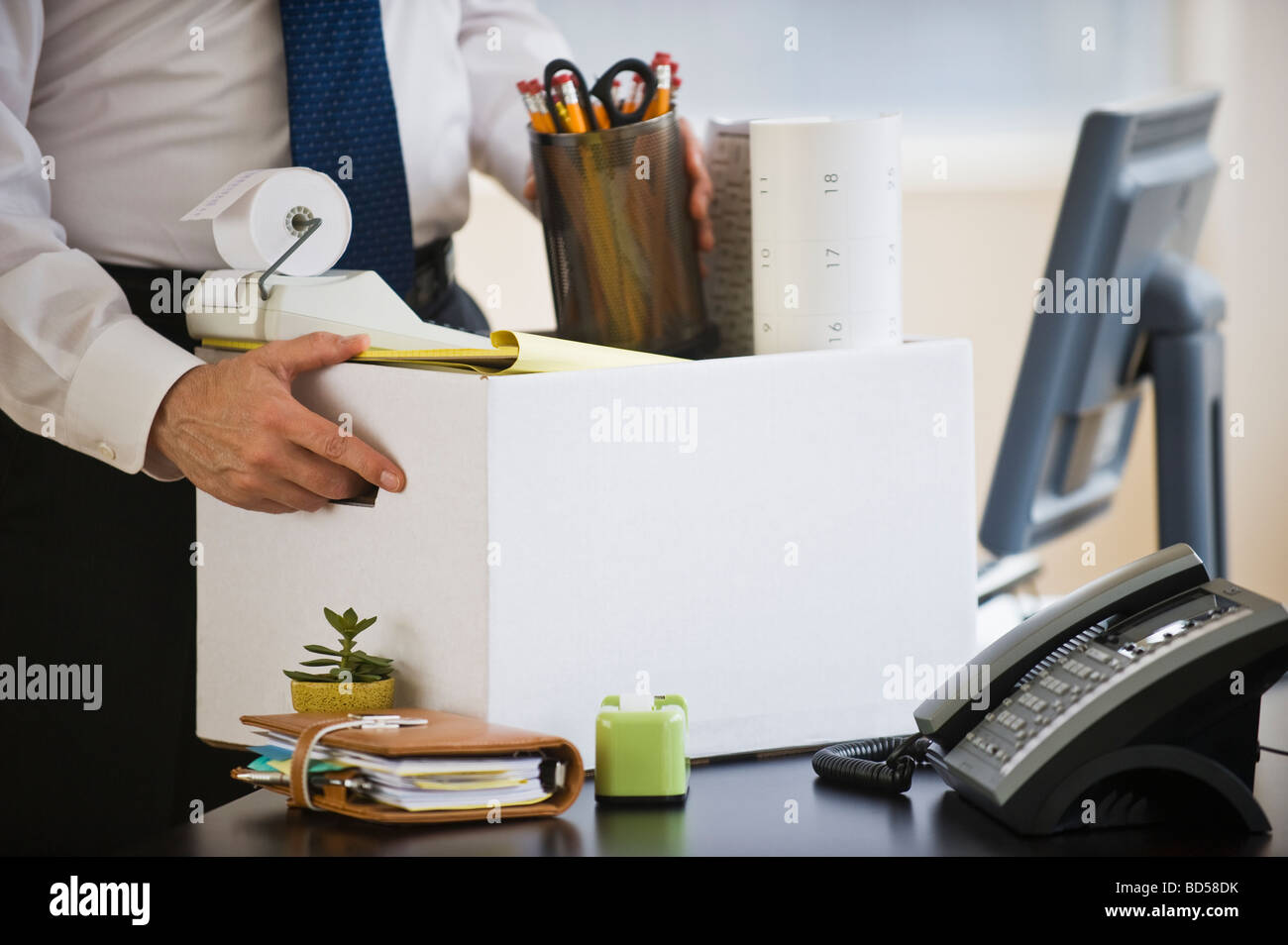 A businessman packing up desk Stock Photo - Alamy