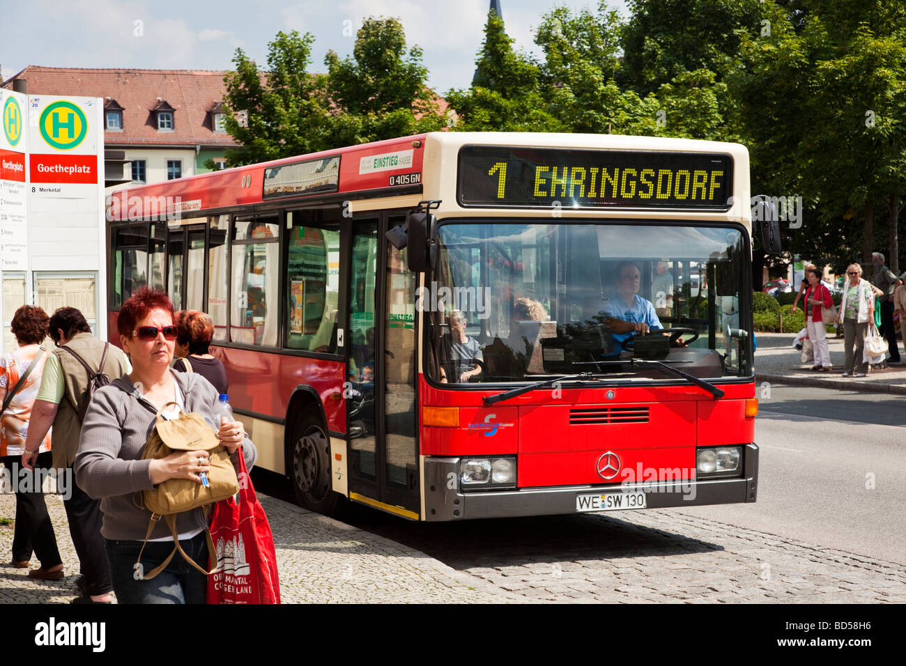 People at a German city centre bus stop in Weimar, Thuringia, Germany ...