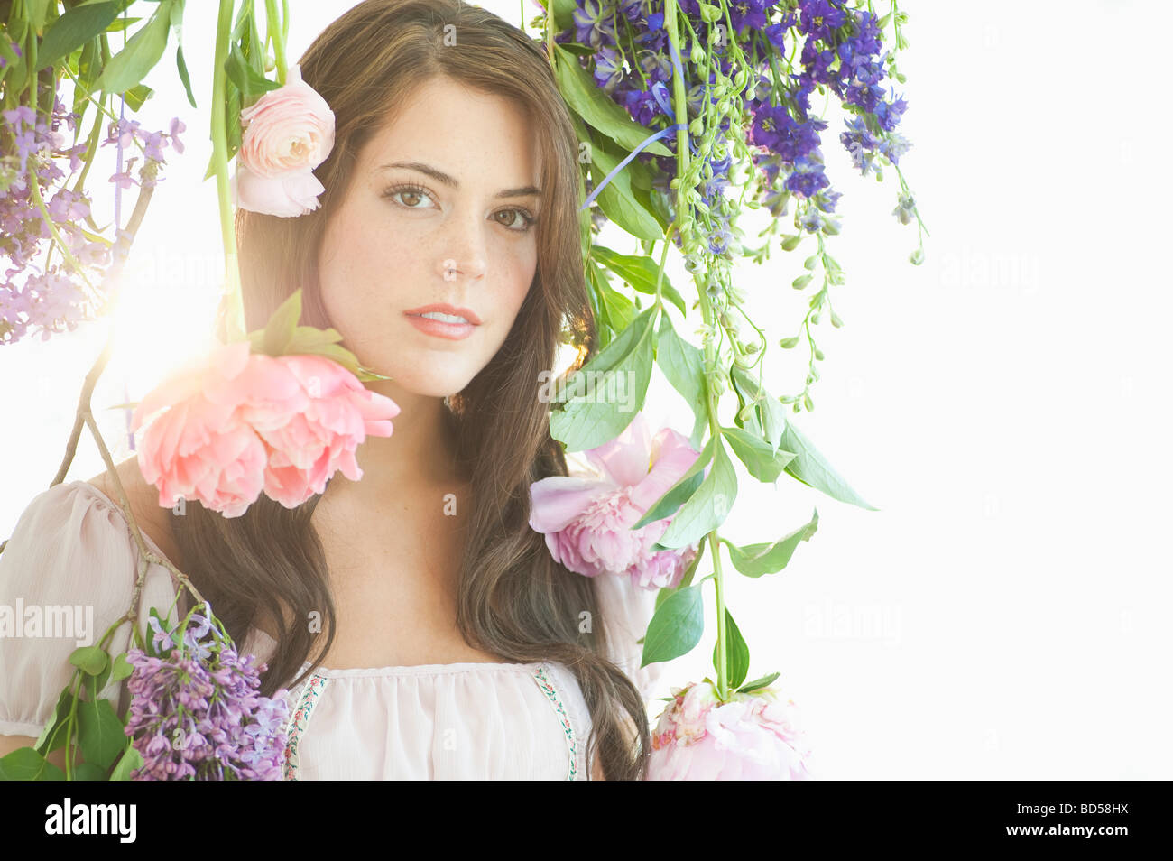 A woman surrounded by flowers Stock Photo - Alamy