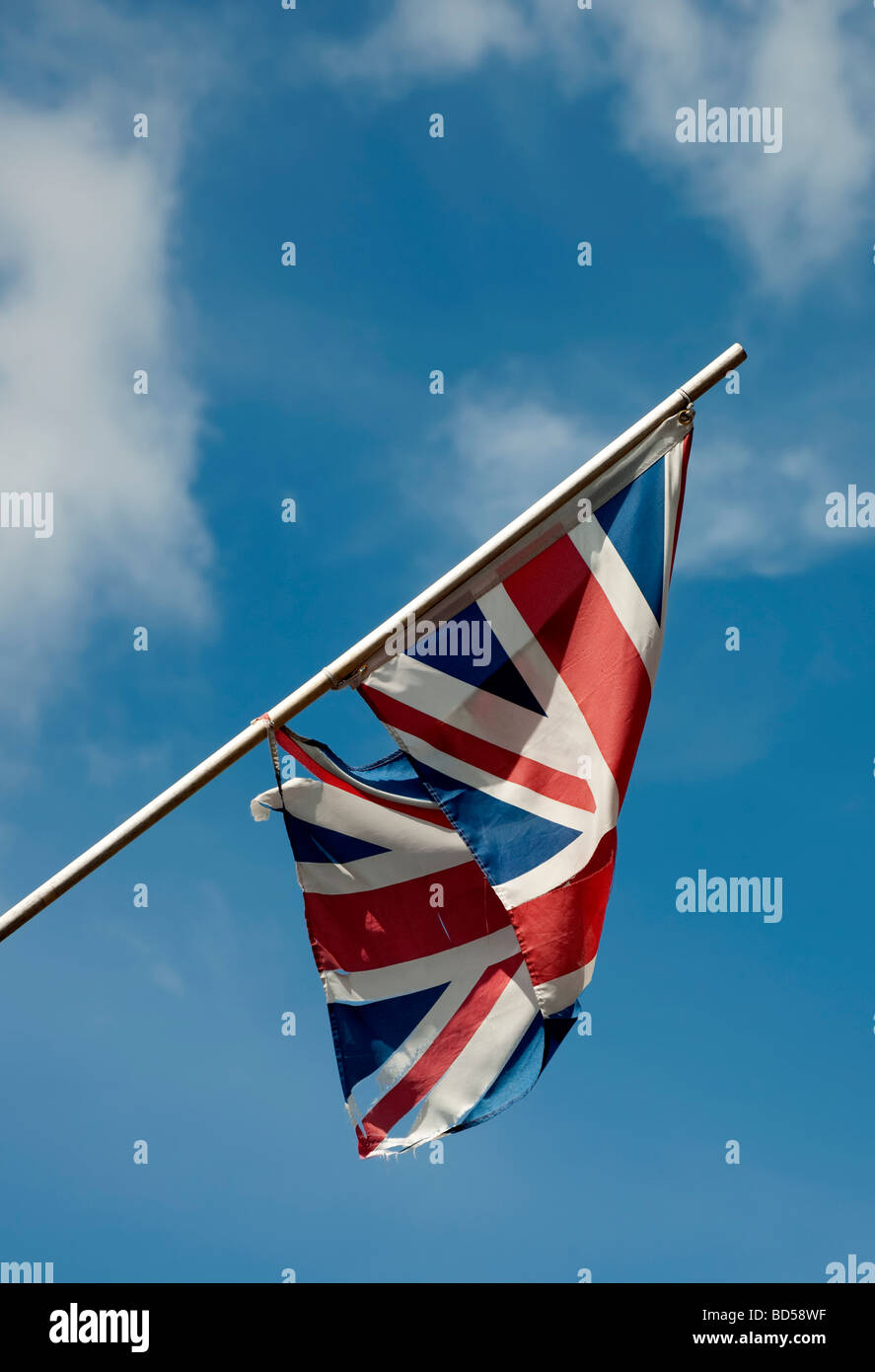 Union Flag flying on pole against blue sky Stock Photo - Alamy